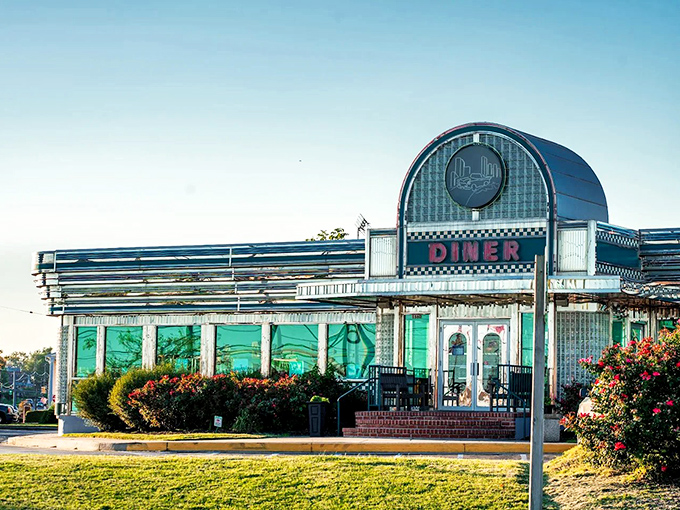 The classic curved facade with its bold "DINER" signage isn't just an entrance—it's a time machine to when comfort food reigned supreme.