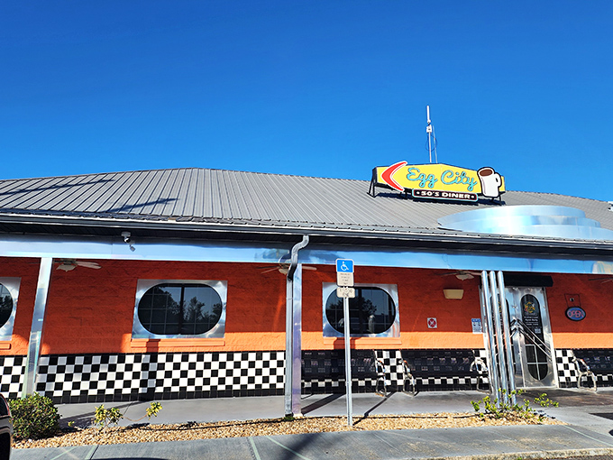 The bright orange exterior with porthole windows isn't just eye-catching—it's a time portal to the 1950s waiting in Haines City. No DeLorean required.