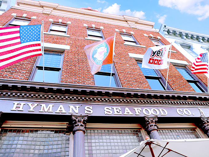 The historic brick facade of Hyman's Seafood stands proudly on Meeting Street, flags fluttering above like a beacon for hungry seafood lovers.