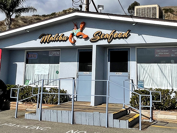The unassuming white facade of Malibu Seafood, where that iconic red lobster sign has been beckoning seafood lovers off PCH for decades.