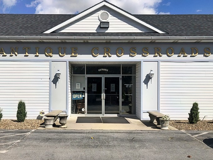The unassuming white exterior of Antique Crossroads belies the wonderland within—like finding Narnia in a suburban strip mall.