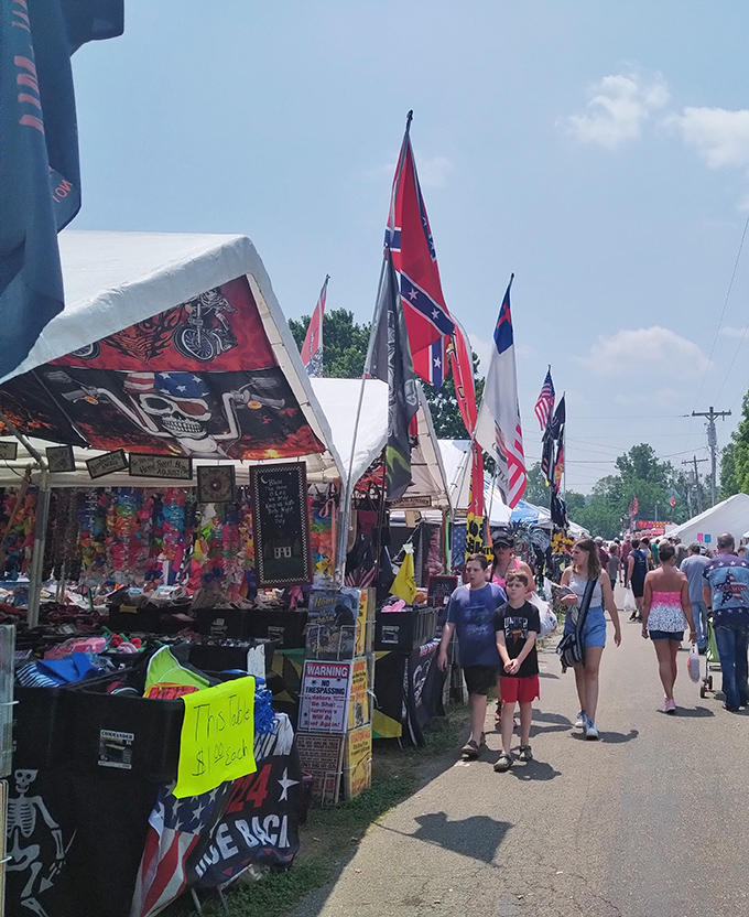 Treasure hunting under blue Indiana skies! The outdoor vendor area transforms into a bustling marketplace where one person's forgotten flag collection becomes another's prized decor.