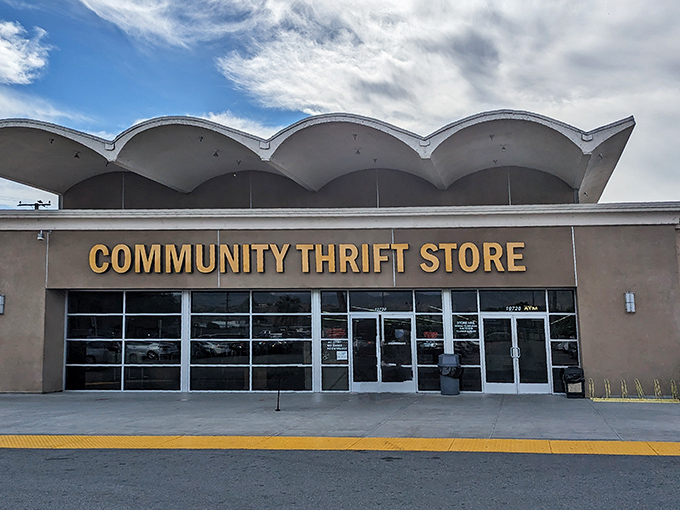 The iconic yellow sign glows like a beacon for bargain hunters, promising treasures within those distinctive wavy-roofed walls.
