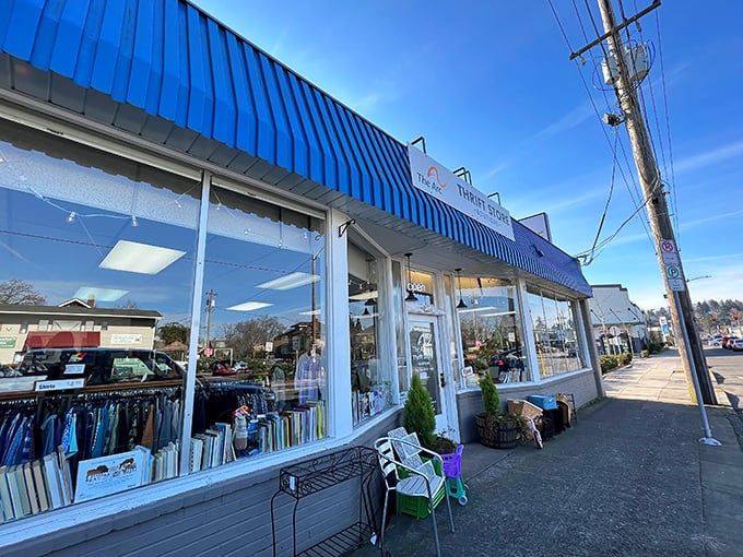 The welcoming storefront of The Arc Thrift Store beckons with its glowing neon sign—like a lighthouse guiding bargain hunters to treasure-filled shores.