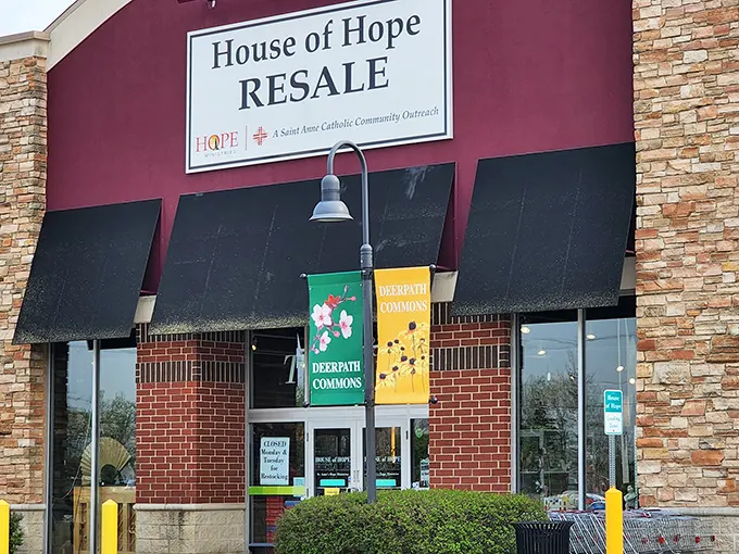 The distinctive red exterior of House of Hope Resale stands out like a beacon for bargain hunters, promising treasures that Walmart could only dream of housing.