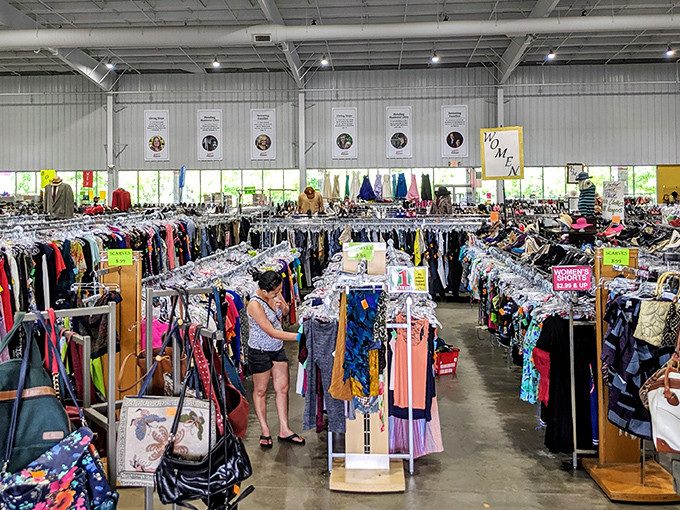 Treasure hunters navigate a sea of clothing racks under soaring ceilings. This isn't just shopping—it's an expedition with purpose.