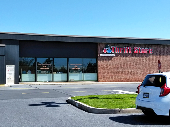 The unassuming brick exterior of CommunityAid belies the treasure trove within—like finding a portal to bargain heaven disguised as a strip mall storefront.