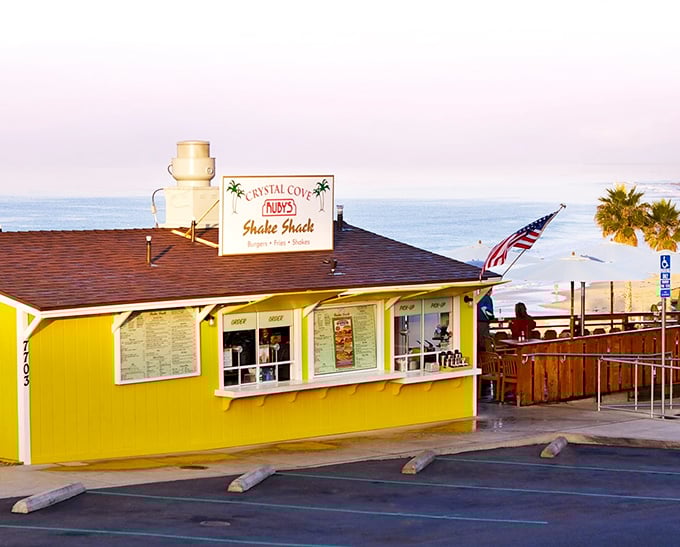 That cheerful yellow beacon on the cliff isn't just a building—it's a promise of burgers with a side of Pacific paradise.
