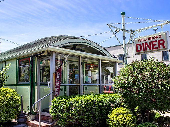 The iconic mint-green exterior of Wellsboro Diner gleams like a time capsule on wheels, inviting hungry travelers to step back into a simpler, more delicious era.