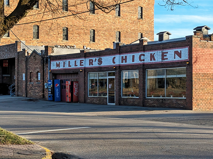 The iconic white and red-painted sign says it all – no fancy frills needed when your chicken speaks volumes through generations of crispy perfection.