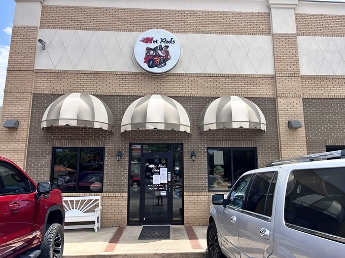 The classic brick exterior with striped awnings isn't just inviting—it's practically waving you in with promises of comfort food nirvana.