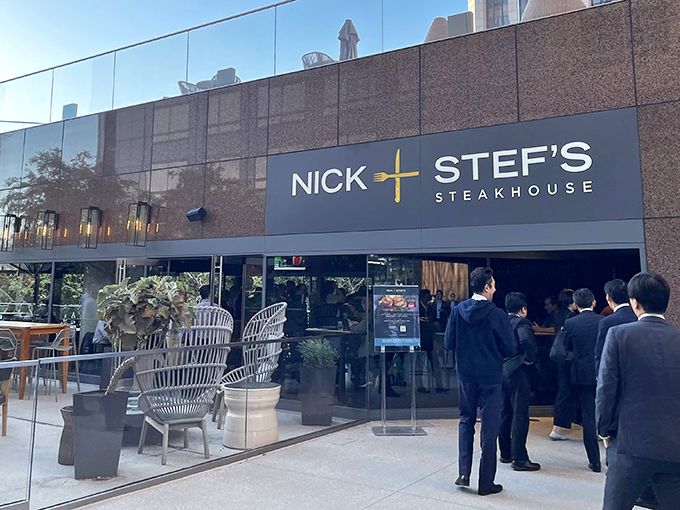 The sleek exterior of Nick and Stef's promises what lies within—a temple of beef where downtown LA's skyline serves as the perfect backdrop for meat-based worship.
