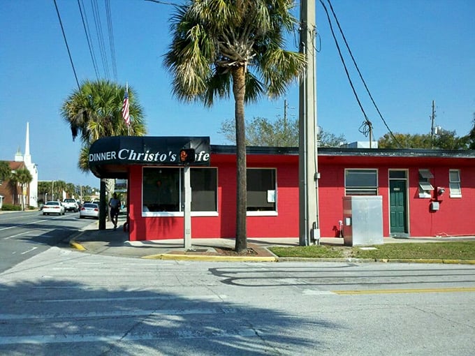 The unmistakable red exterior of Christo's Café stands out like a culinary lighthouse, beckoning hungry travelers with promises of breakfast bliss in Orlando.