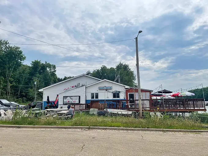 The unassuming blue-trimmed exterior of Kuchie's on the Water might not scream "culinary destination," but that's part of its charm—the real magic awaits inside.