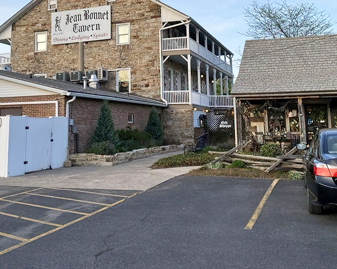 The historic limestone facade of Jean Bonnet Tavern stands proudly in Bedford, where patriotic bunting adds a touch of Americana to this centuries-old landmark.