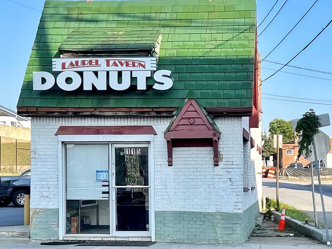The iconic green-shingled roof and weathered "DONUTS HAMBURGERS" sign announce this Laurel institution without fanfare—architectural honesty at its most delicious.