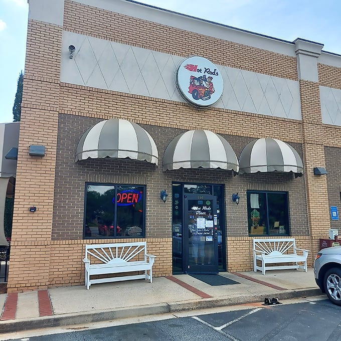 The classic brick exterior with striped awnings isn't just inviting—it's practically waving you in with promises of comfort food nirvana.