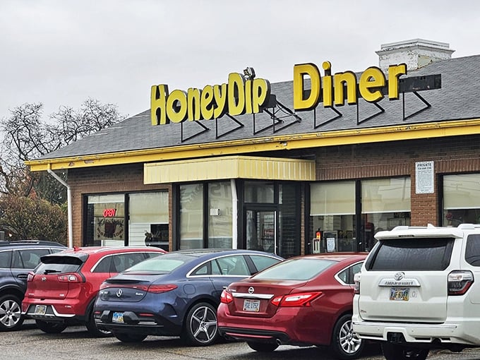 The bright yellow HoneyDip sign beckons like a breakfast lighthouse, guiding hungry souls to this Columbus institution where calories don't count before noon.