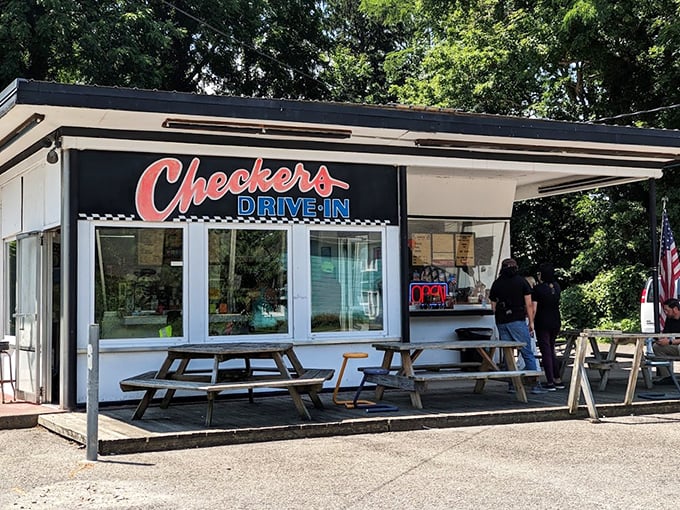 The classic black-and-white checkered pattern isn't just decoration—it's a beacon calling hungry travelers to this slice of Americana in Perry.