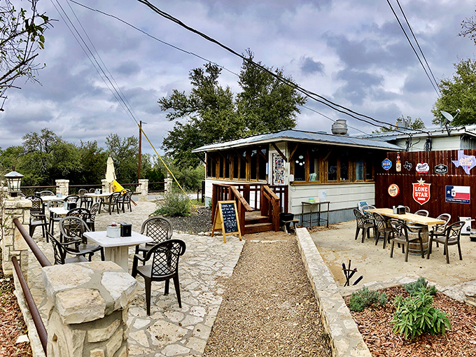The humble exterior of Alamo Springs Café belies the culinary treasures within. Texas Hill Country magic awaits on this rustic patio.