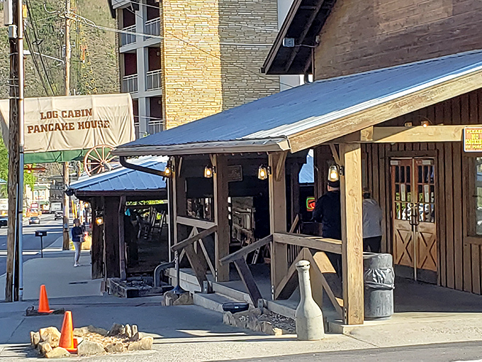 That covered wagon on the roof isn't just decoration—it's a beacon calling hungry travelers to breakfast paradise in the Smokies.