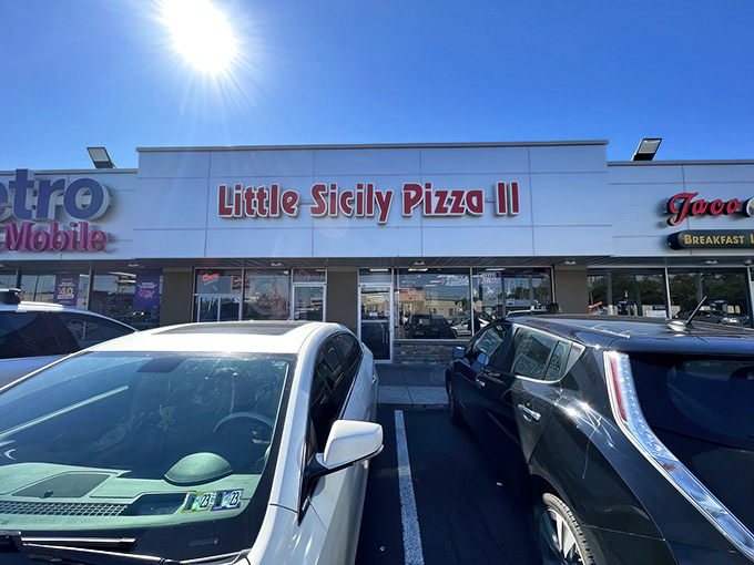 The bright red sign of Little Sicily Pizza 2 beckons like a lighthouse for the hungry. Philadelphia's culinary odd couple – Italian tradition meets Indian spice – hiding in plain sight.