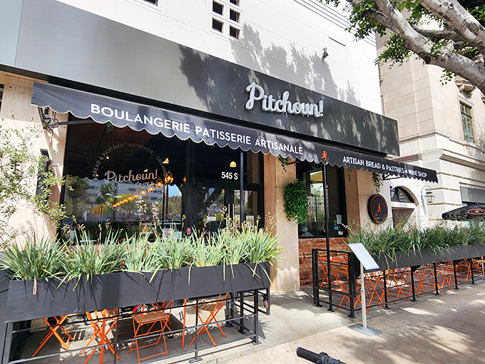 The sleek black awning of Pitchoun! promises Parisian delights in downtown LA. Orange chairs beckon you to linger over coffee and watch the world go by.