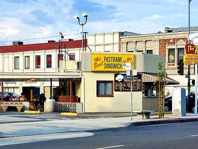 The iconic yellow sign promises "The Best Pastrami Sandwich in the World" – a bold claim The Hat has been backing up for decades.