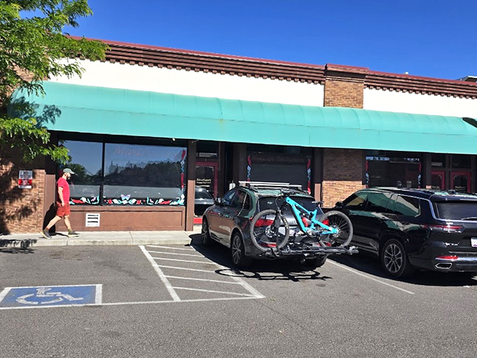 The unassuming exterior hides culinary treasures within. That turquoise awning is like a beacon calling hungry travelers home.