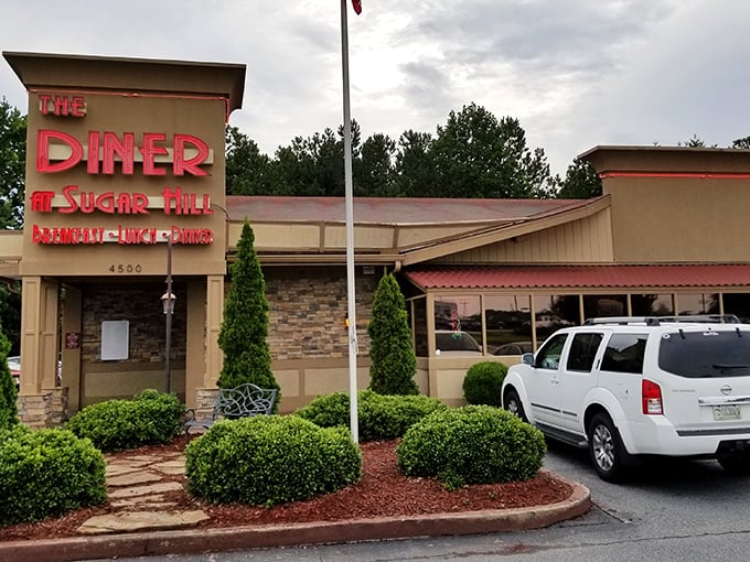 The iconic red neon sign beckons hungry travelers like a lighthouse for the famished. Home cooking awaits behind those doors.