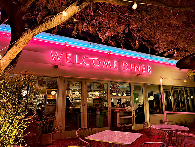 The iconic red lettering beckons hungry travelers like a desert mirage, promising comfort food salvation under the shade of Arizona mesquite trees.