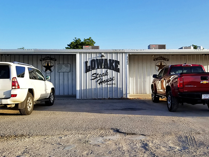 The unassuming façade of Lowake Steak House stands like a beef temple in the Texas plains. Pickup trucks flank the entrance, their drivers soon to be converts.