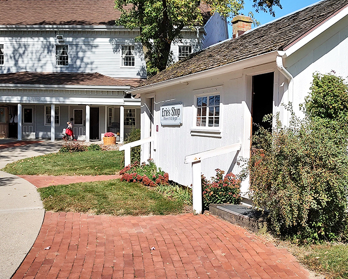 The charming exterior of Sauder Village welcomes visitors with classic white buildings and brick pathways—rural Ohio's version of a time machine.