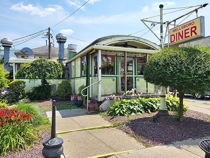 The iconic mint-green exterior of Wellsboro Diner gleams like a time capsule on wheels, inviting hungry travelers to step back into a simpler, more delicious era.