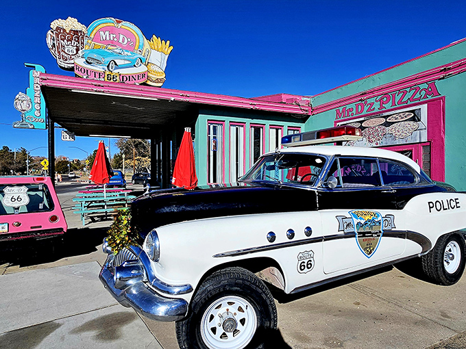 That turquoise and pink exterior isn't just a building—it's a time machine disguised as a diner. Even the local police can't resist stopping by!