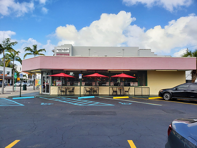 That coral-red facade isn't just a building—it's a beacon of breakfast hope in Miami's sea of trendy eateries.