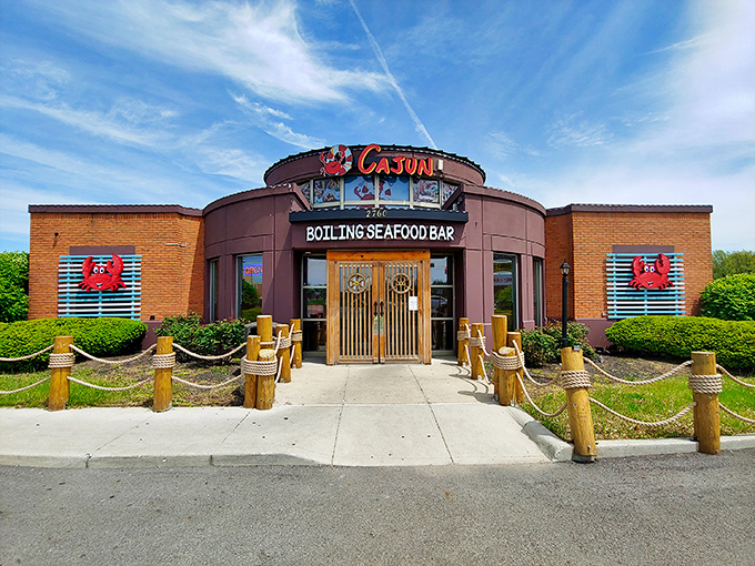 The circular fortress of flavor announces itself boldly on Taylor Road, where those wooden posts and nautical ropes aren't just decoration—they're foreshadowing the hands-on adventure waiting inside.