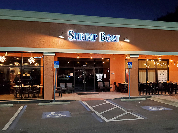 The orange exterior might not scream "culinary destination," but that glowing sign is like a lighthouse guiding hungry seafood lovers to shore.