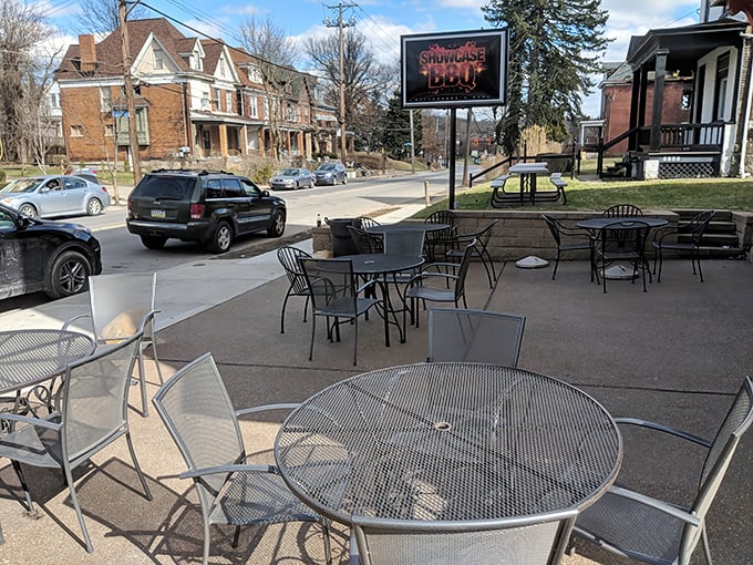 The unassuming brick exterior of Showcase BBQ belies the culinary treasures within. Those patio tables have witnessed countless barbecue epiphanies.