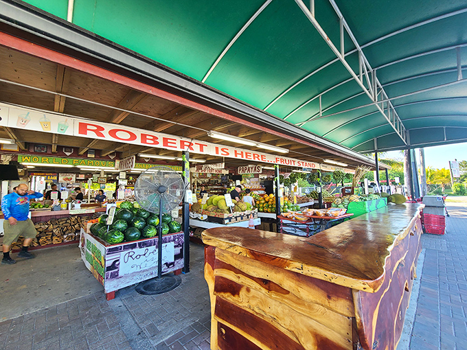 The wooden counter stretches like a rustic welcome mat, with "ROBERT IS HERE" proudly announcing itself to fruit pilgrims seeking tropical treasures.
