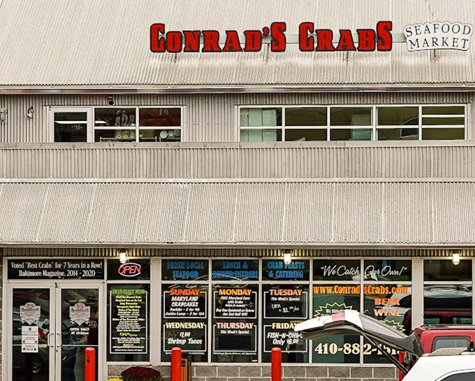 The unassuming exterior of seafood paradise – where Maryland's best crabs hide behind a humble façade and those red bollards stand guard like sentinels protecting treasure.