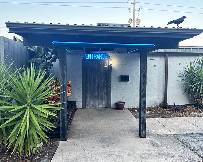 That blue neon "ENTRANCE" sign isn't just an invitation—it's a portal to steak paradise hiding behind an unassuming Florida facade.