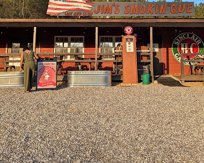The American flag-inspired roof above Jim's Smokin' Que isn't just patriotic—it's a beacon for BBQ pilgrims. That vintage gas pump promises fuel of a different kind.