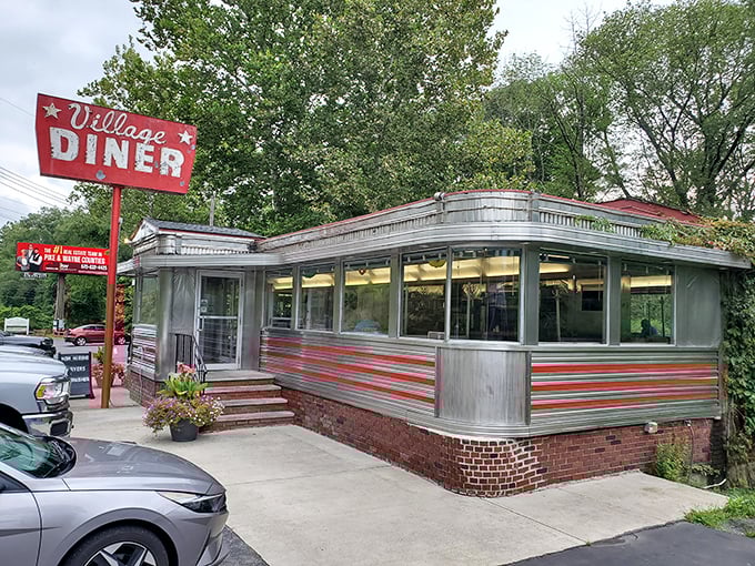 The classic red sign beckons like a time machine to simpler days, when chrome gleamed and burgers sizzled without irony or pretension.