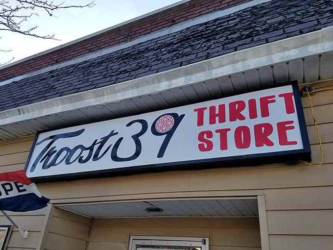 The unassuming storefront of Troost39 beckons with its bold red lettering – fashion paradise disguised as a humble thrift shop.