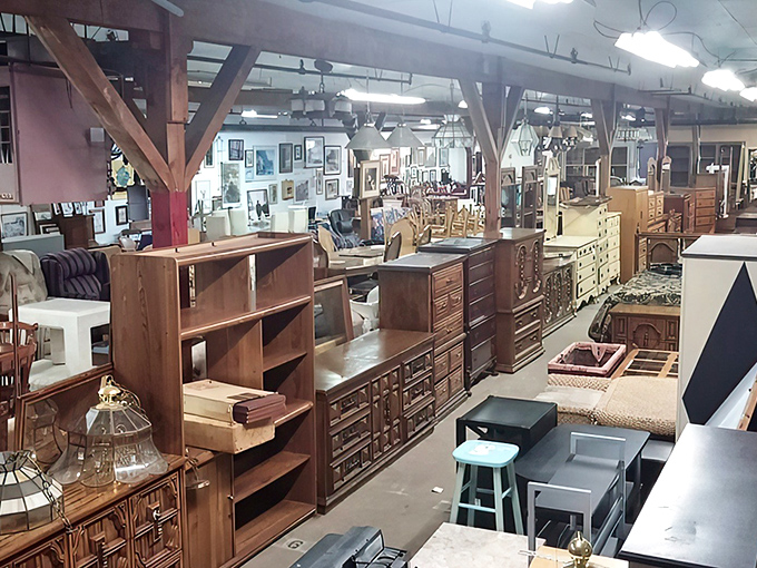 Row after row of solid wood furniture stretches into the distance, each piece silently whispering stories of dinners, conversations, and lives once lived.