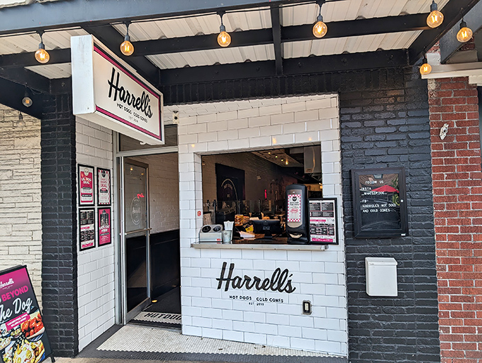 Harrell's storefront welcomes you with vintage charm and modern flair—where Edison bulbs and white subway tiles promise hot dog nirvana just steps from Winter Garden's brick-lined streets.