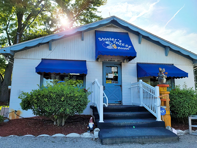 The little white building with bright blue awnings isn't trying to impress anyone—until you taste what's inside. Ohio's cheese paradise hiding in plain sight.