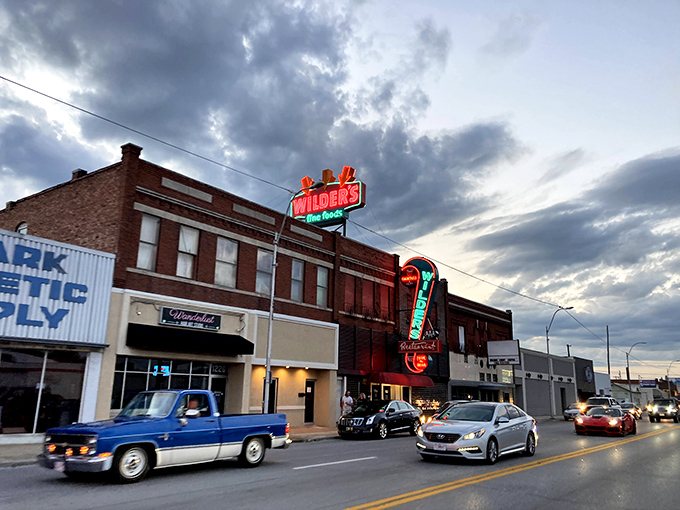 That neon sign isn't just advertising – it's a beacon of hope for hungry travelers. The vintage glow promises carnivorous delights await inside.