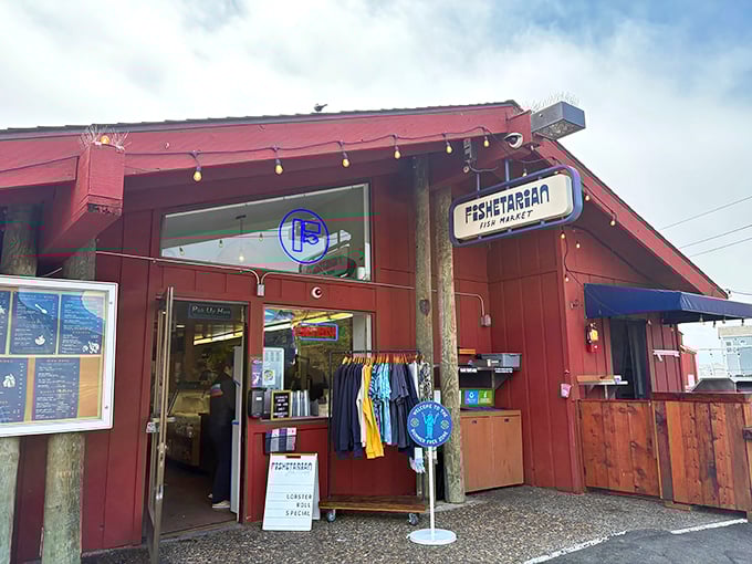 The unassuming red exterior of Fishetarian Fish Market, where that cheerful crab sign promises seafood treasures that outshine many white-tablecloth establishments along the coast.